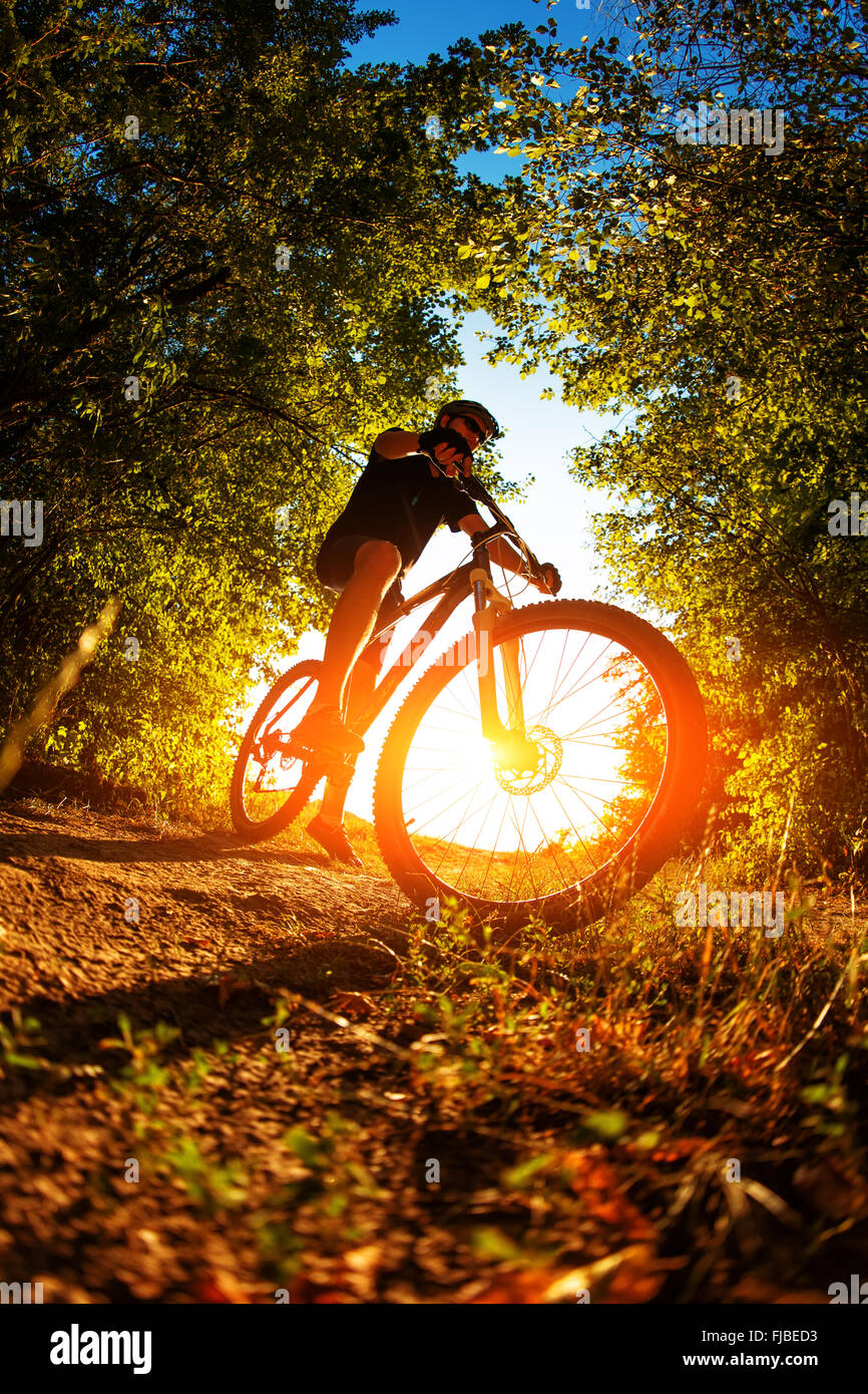 Man Cyclist with bike on sunset Stock Photo - Alamy