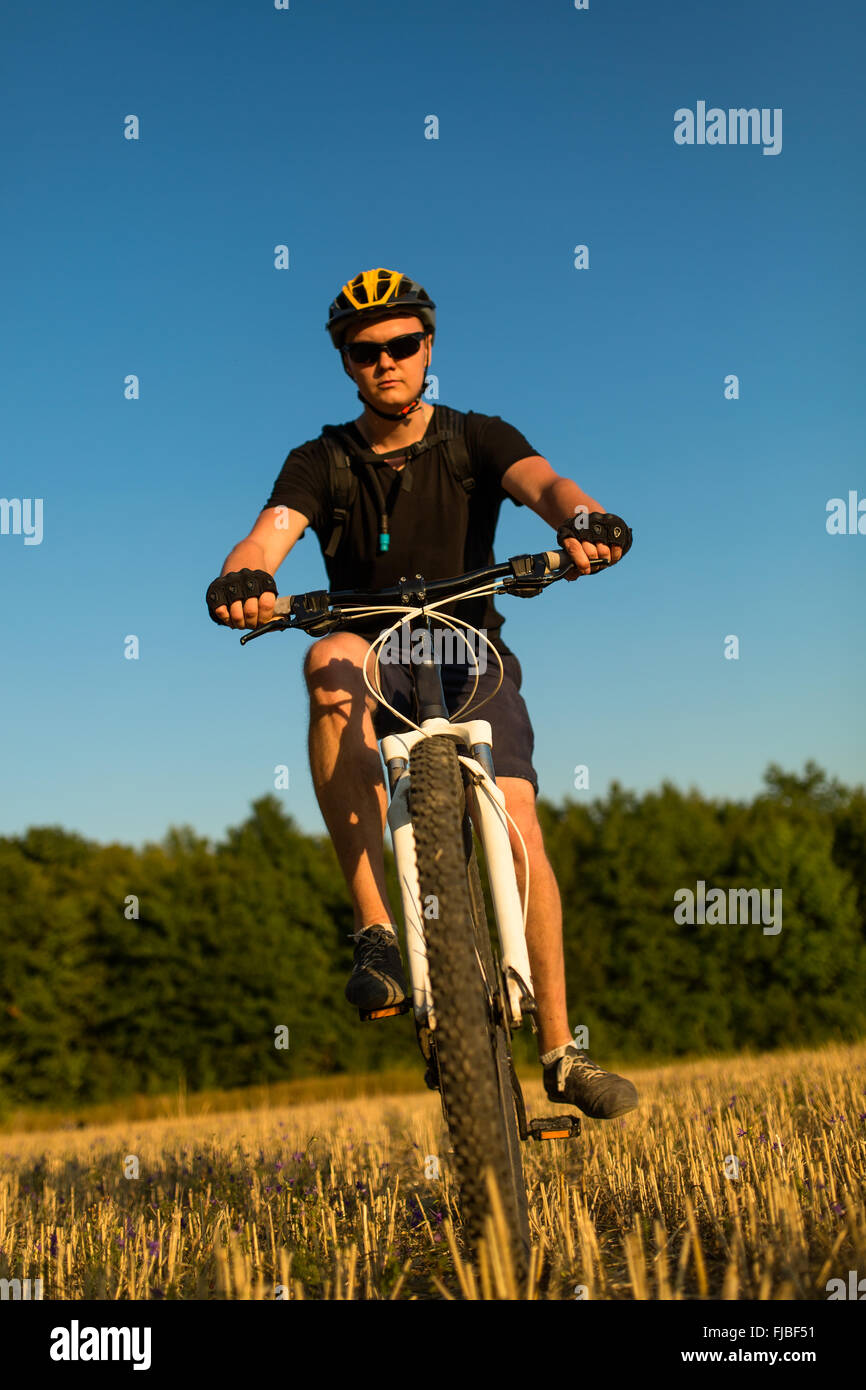 Rider on Mountain Bicycle it the field Stock Photo - Alamy