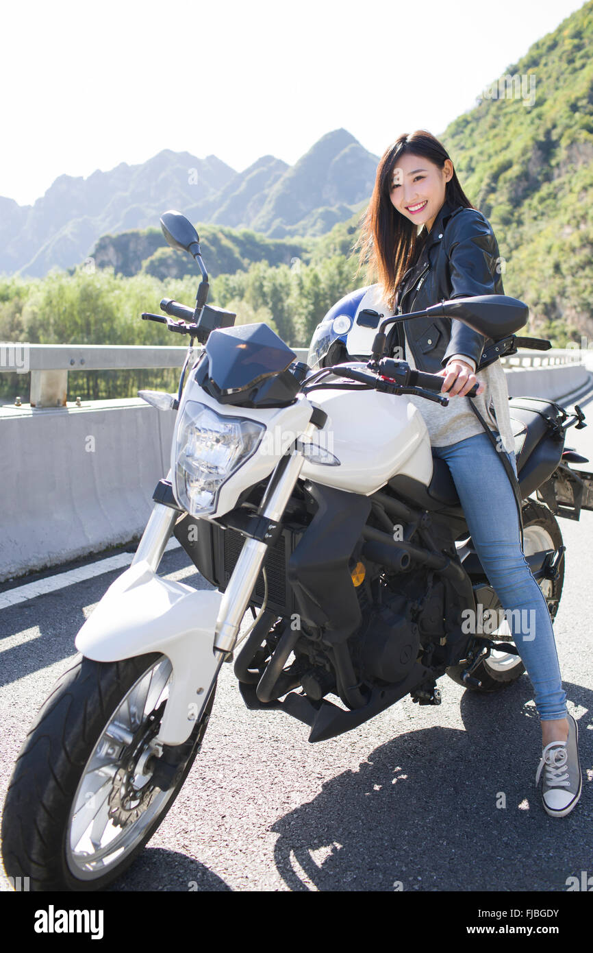 Young Chinese woman riding motorcycle Stock Photo - Alamy