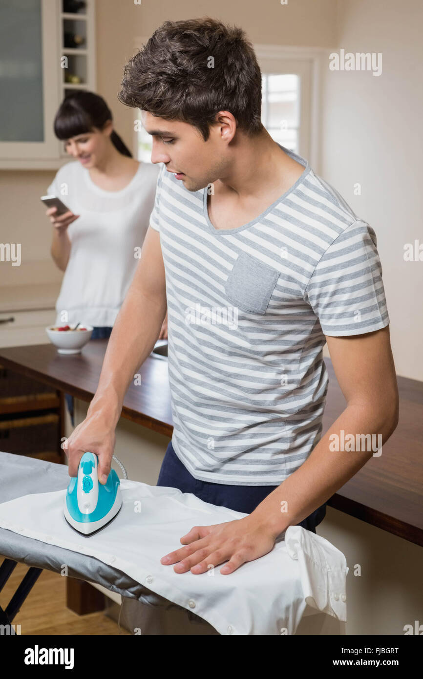 Man ironing a shirt Stock Photo - Alamy