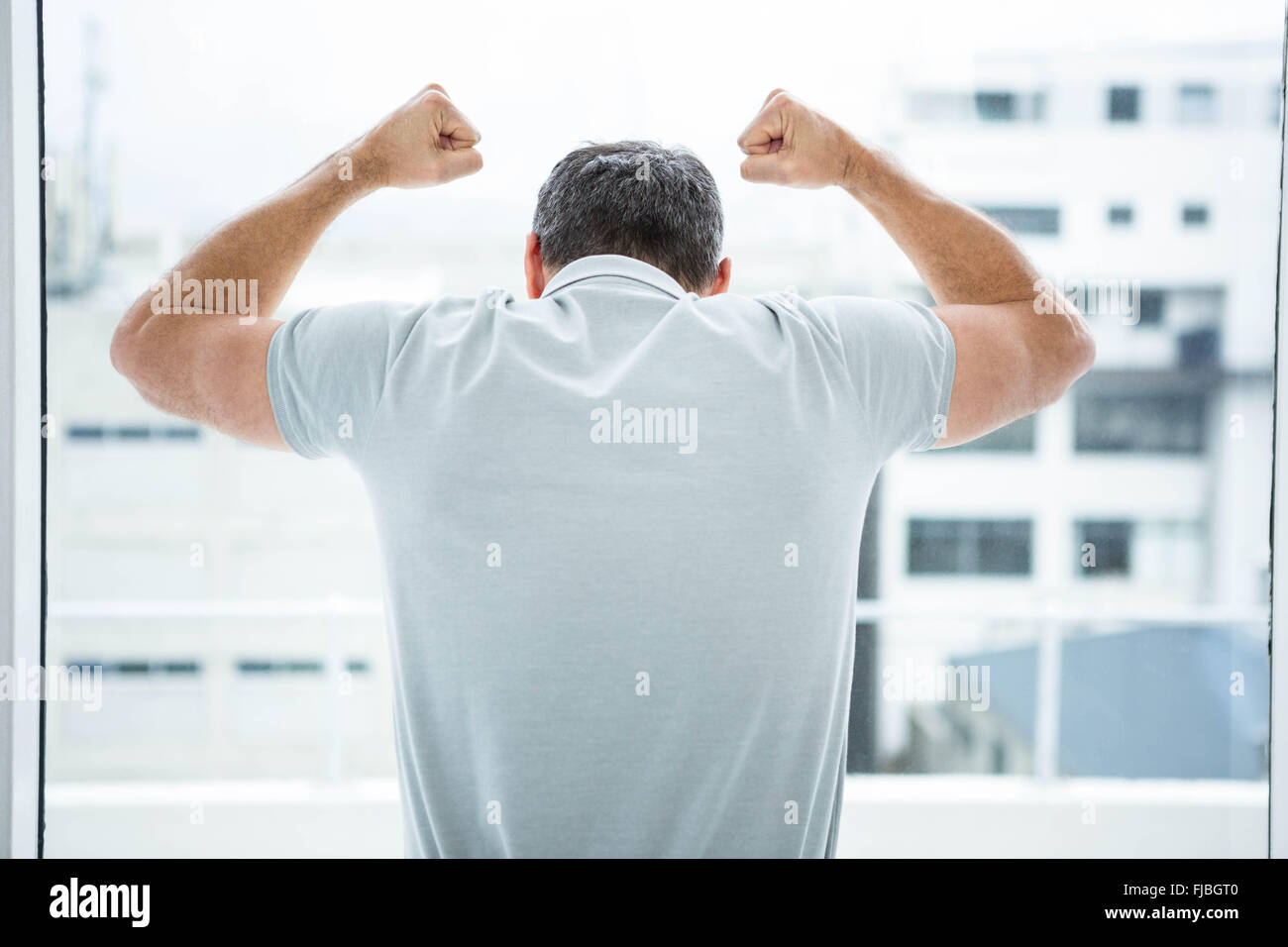 Tensed man leaning on glass window Stock Photo - Alamy