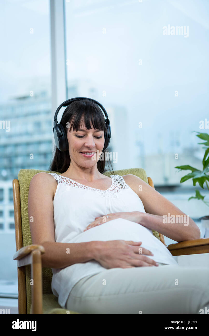 Pregnant woman sitting on chair Stock Photo - Alamy