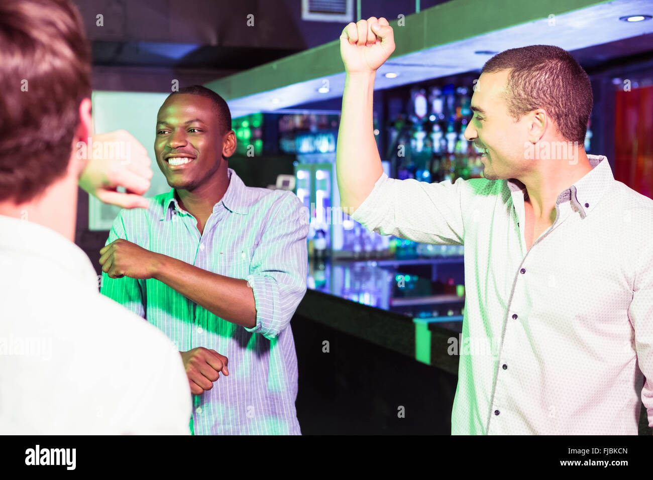 Group of men dancing near bar counter Stock Photo - Alamy