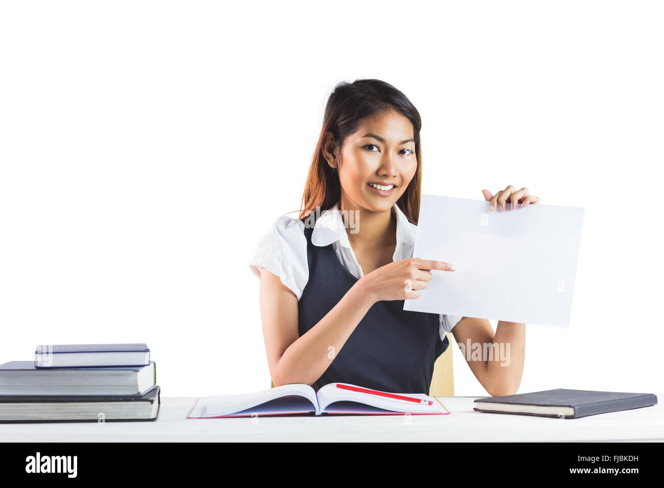 Smiling businesswoman pointing a sheet of paper Stock Photo - Alamy