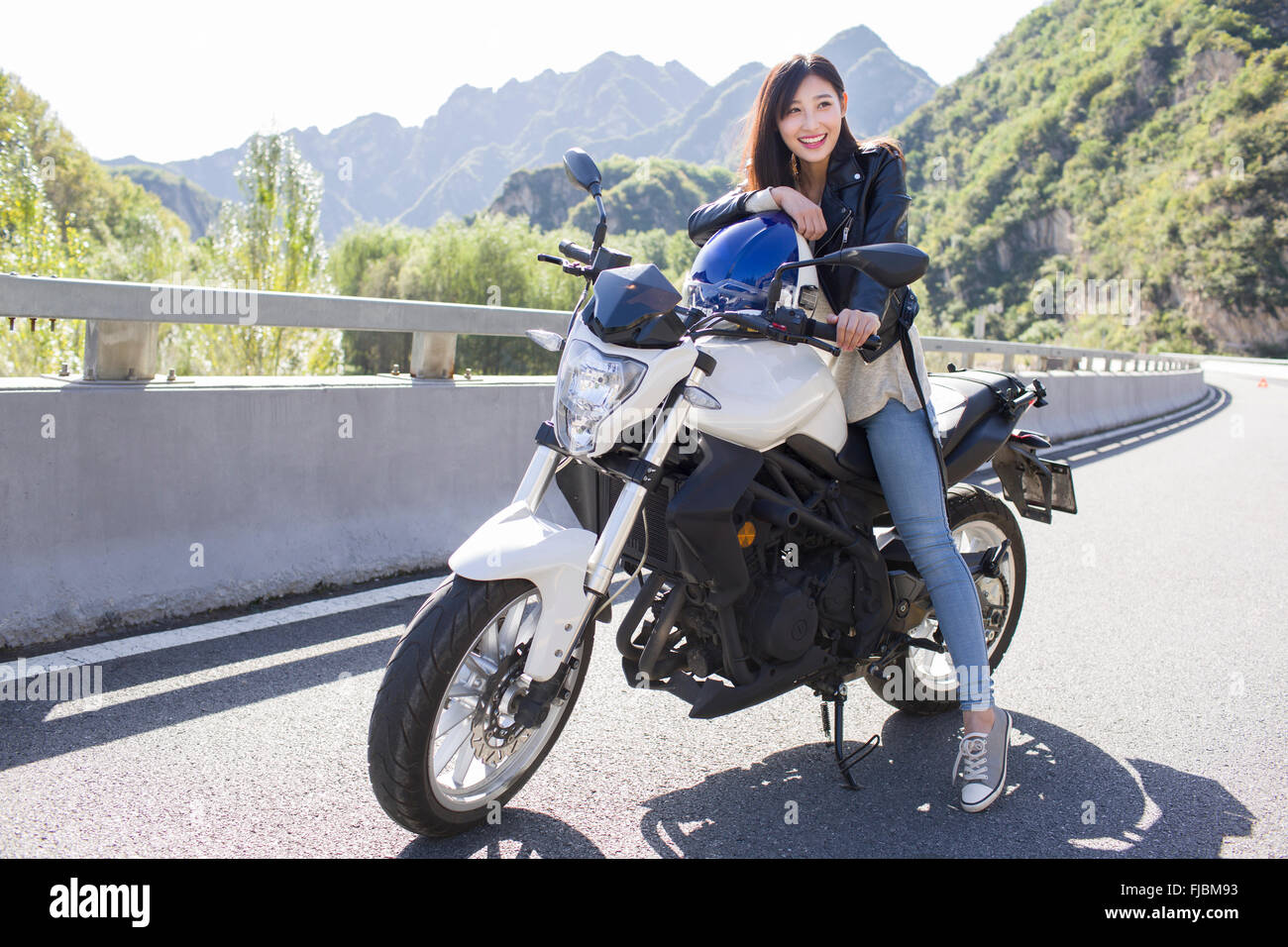 Young Chinese woman riding motorcycle Stock Photo - Alamy
