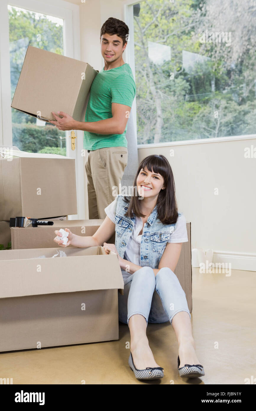 Young woman unpacking carton boxes Stock Photo - Alamy
