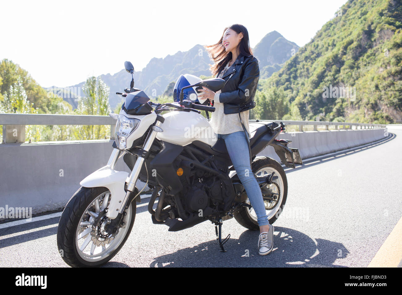 Young Chinese woman riding motorcycle Stock Photo - Alamy