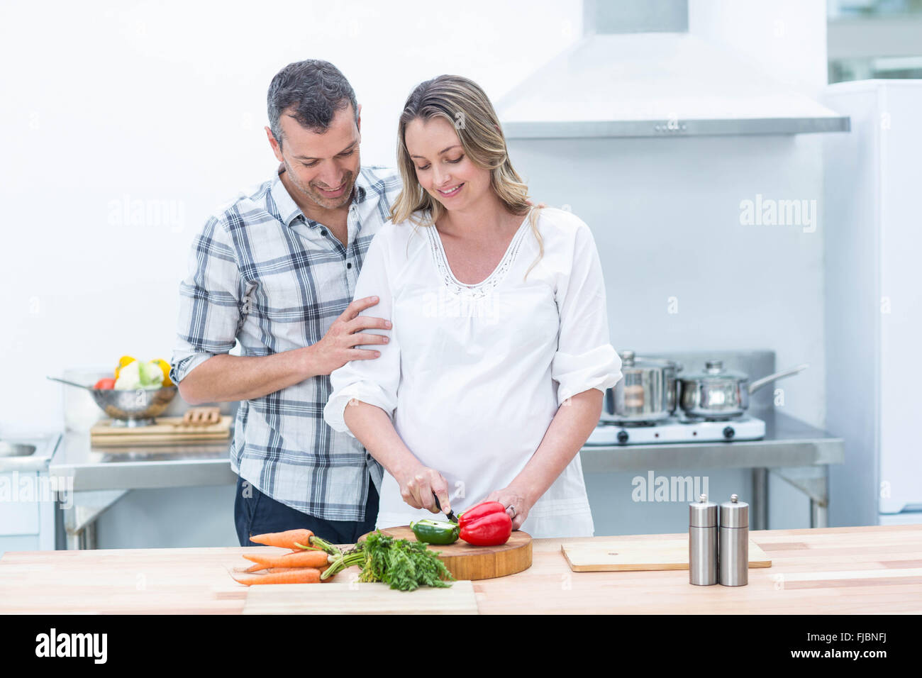 Pregnant woman busy in kitchen Stock Photo - Alamy