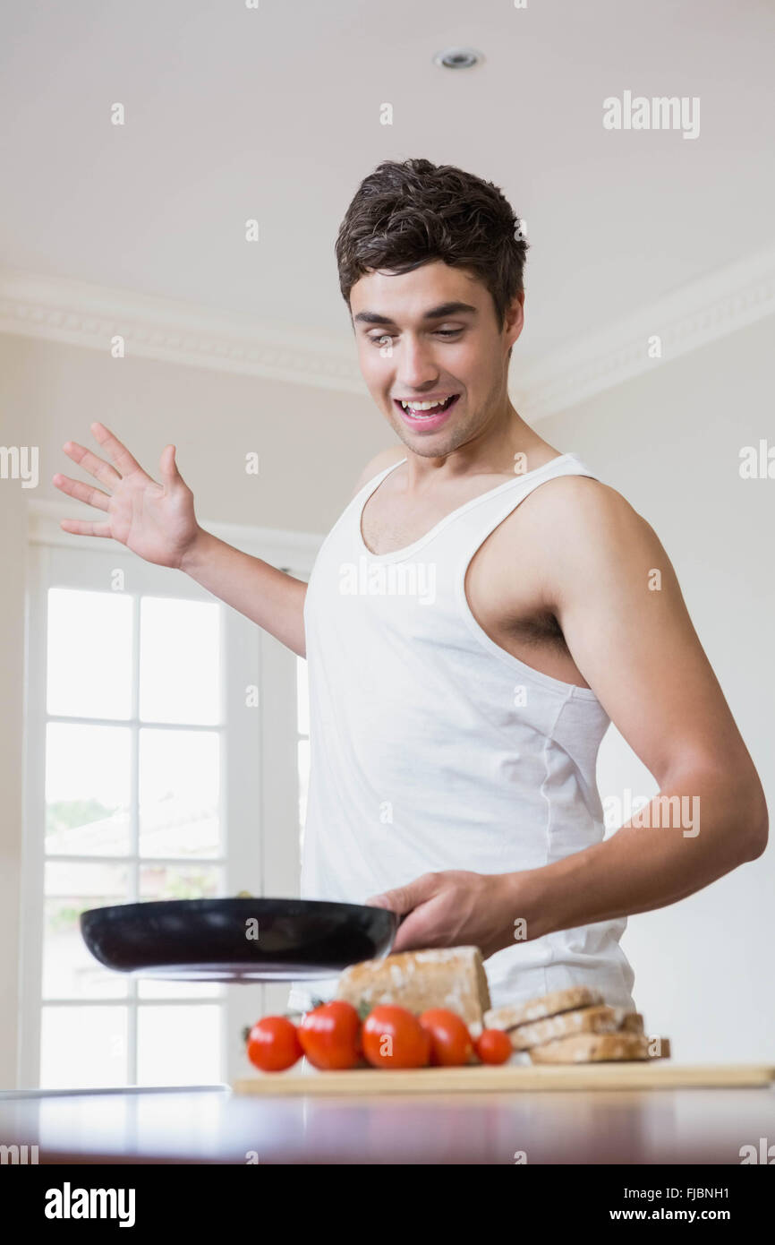 Young man cooking food in kitchen Stock Photo - Alamy