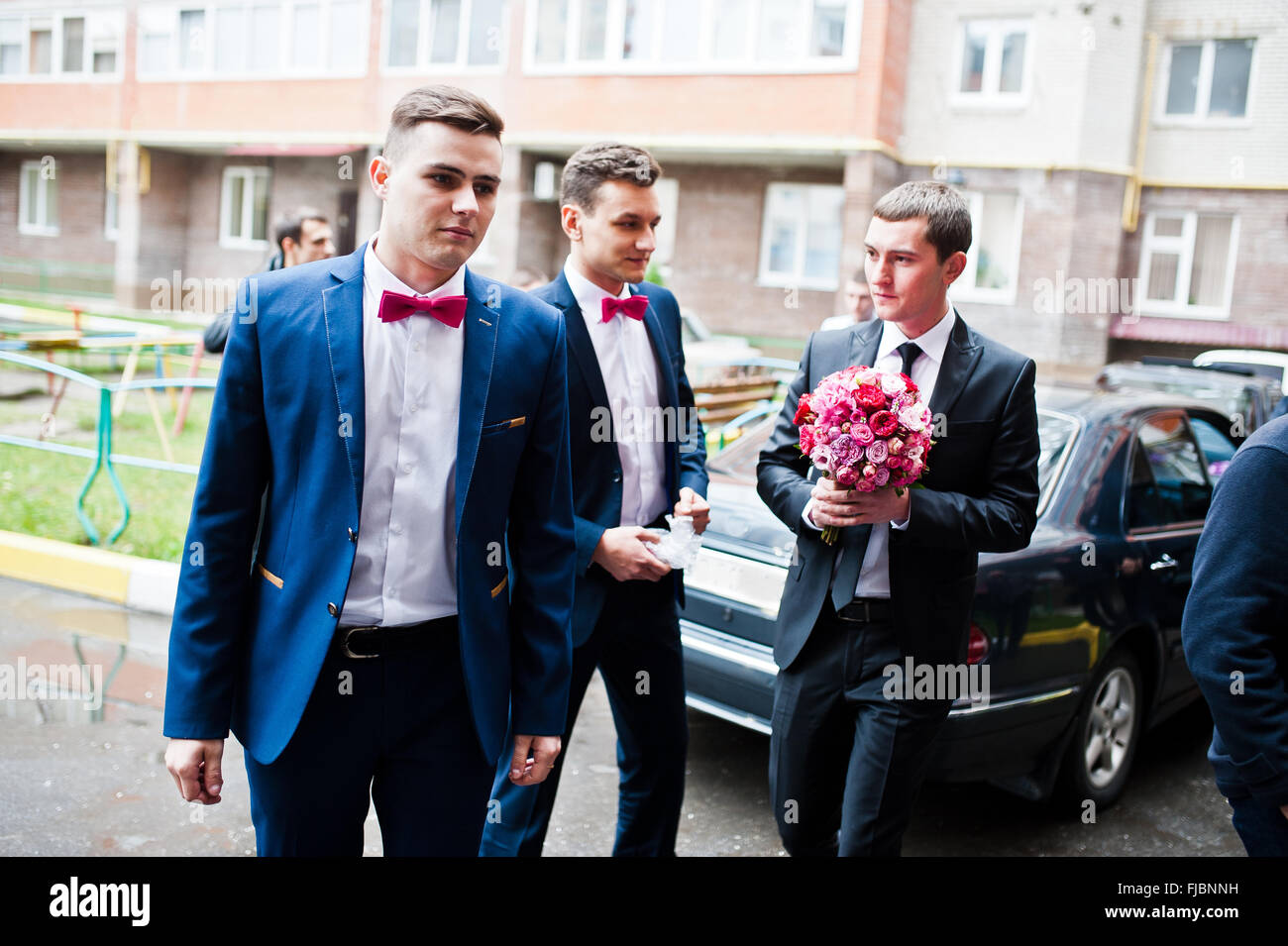 Groom with groomsman background wedding cars Stock Photo - Alamy