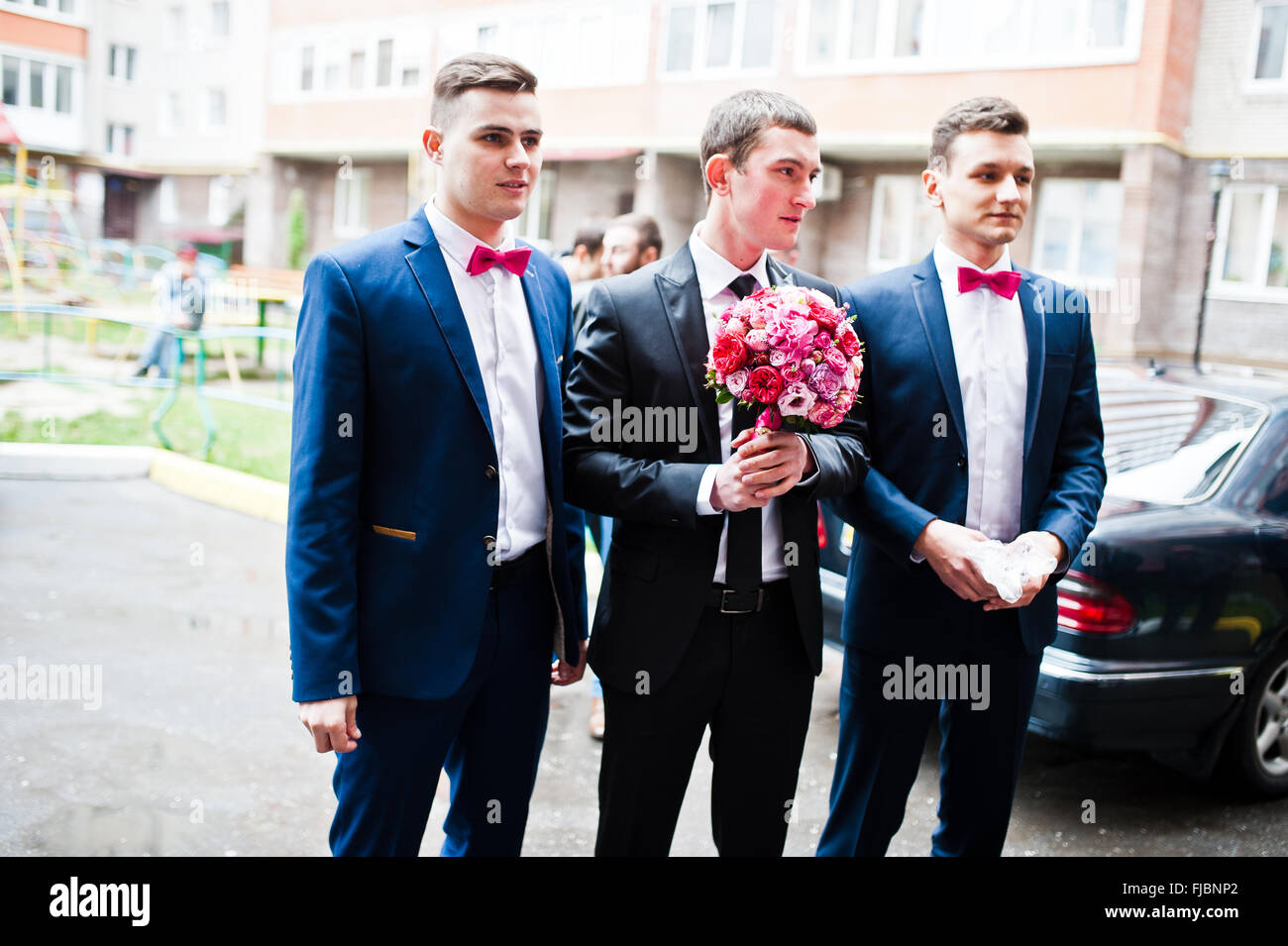 Groom with groomsman background wedding cars Stock Photo - Alamy