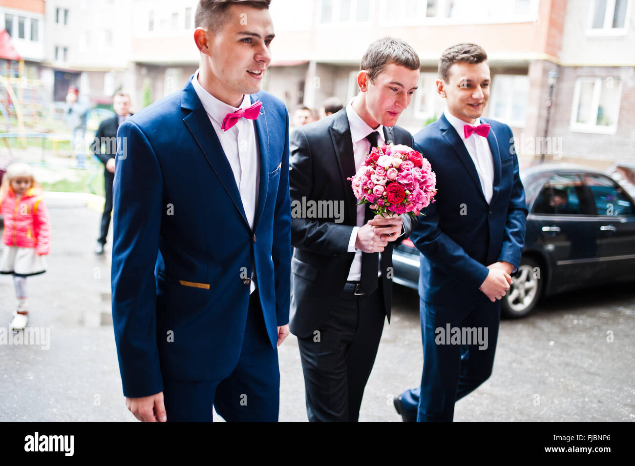 Groom with groomsman background wedding cars Stock Photo - Alamy