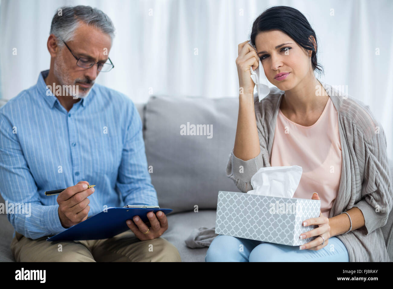 Therapist consoling a woman Stock Photo - Alamy