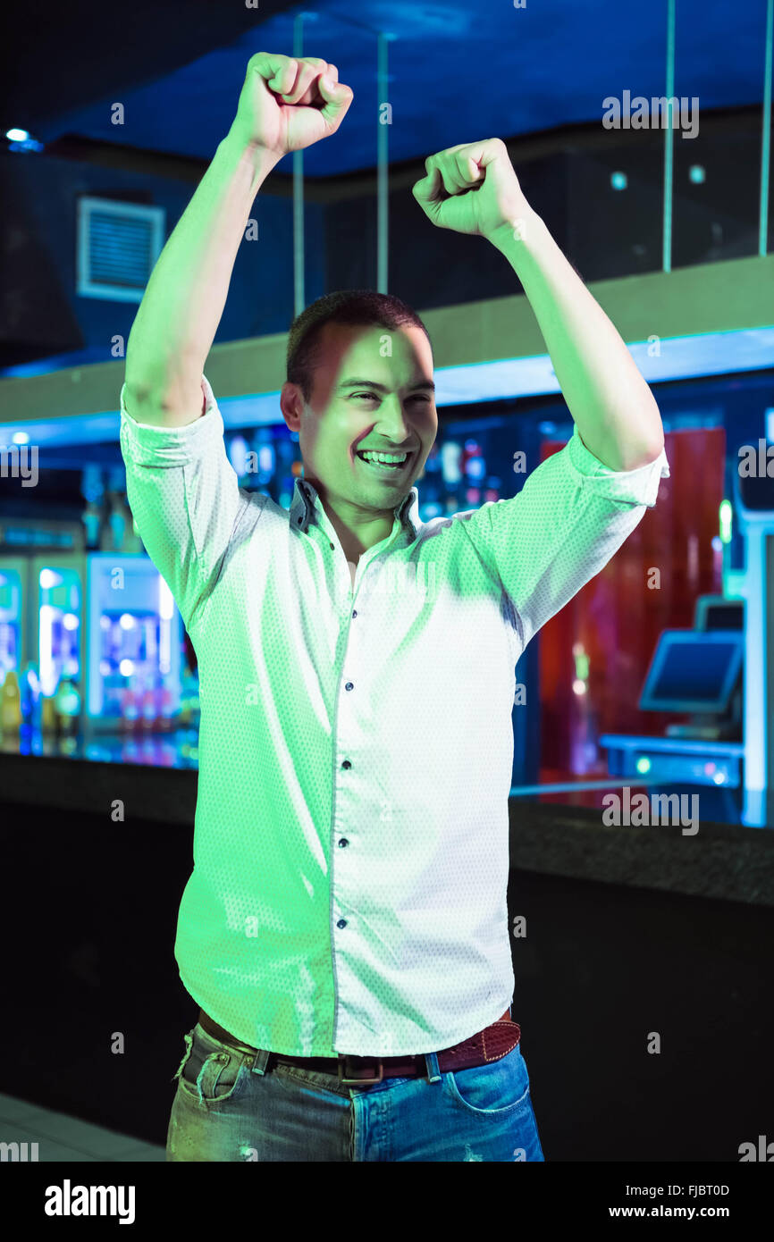 Happy man dancing in front of bar counter Stock Photo - Alamy
