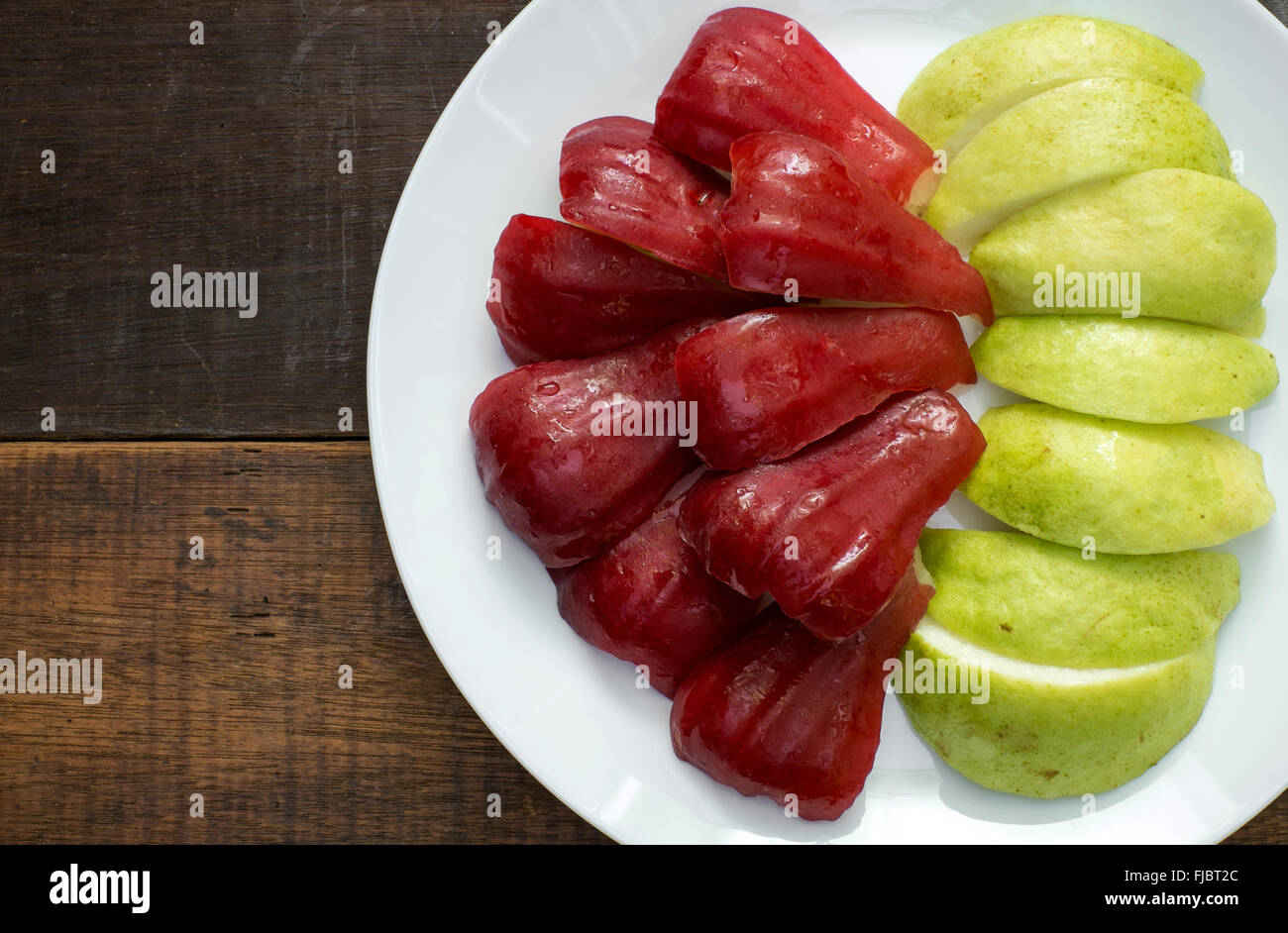 slice guava and rose apple on wood table Stock Photo - Alamy