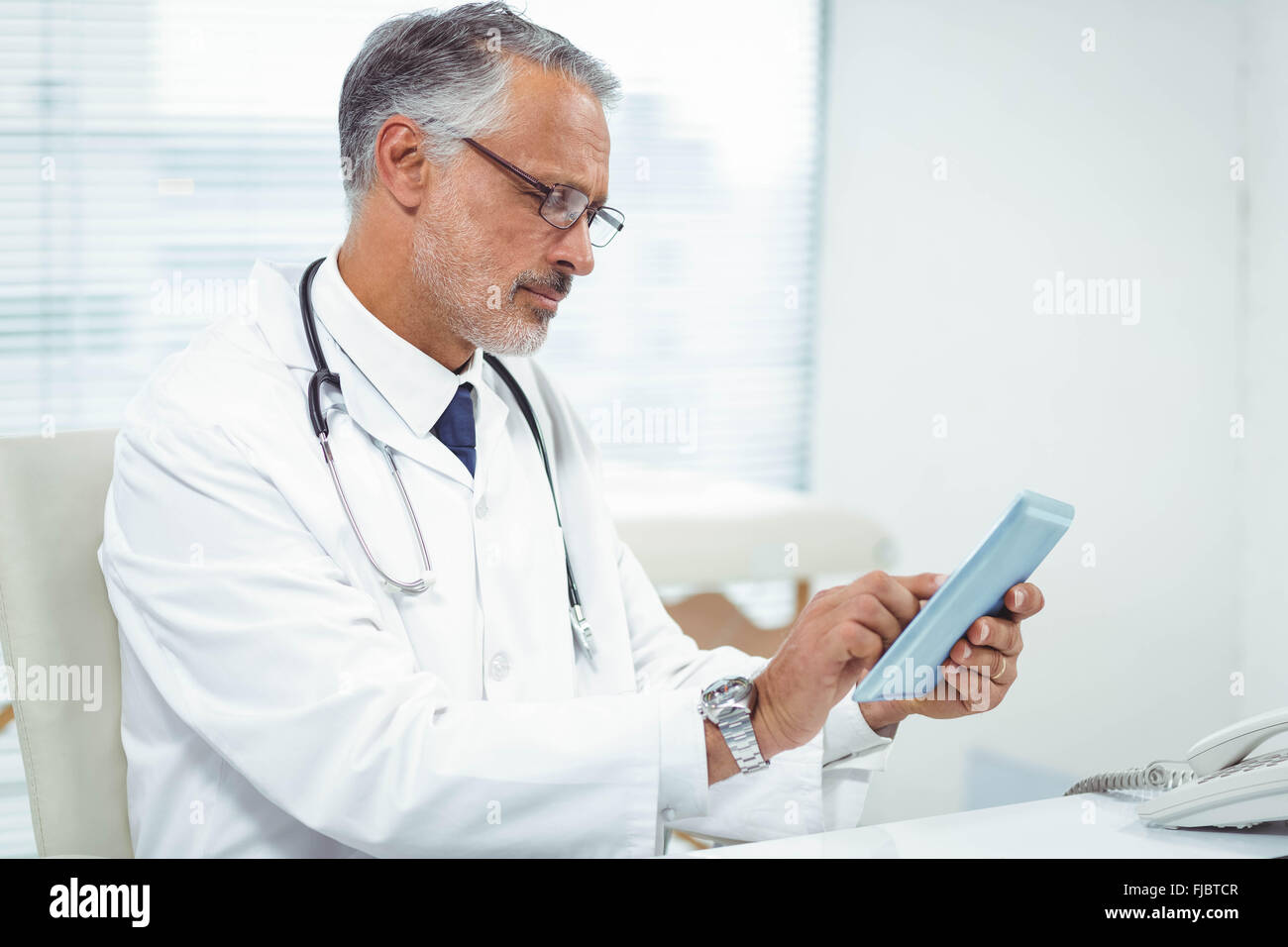 Doctor using digital tablet Stock Photo - Alamy