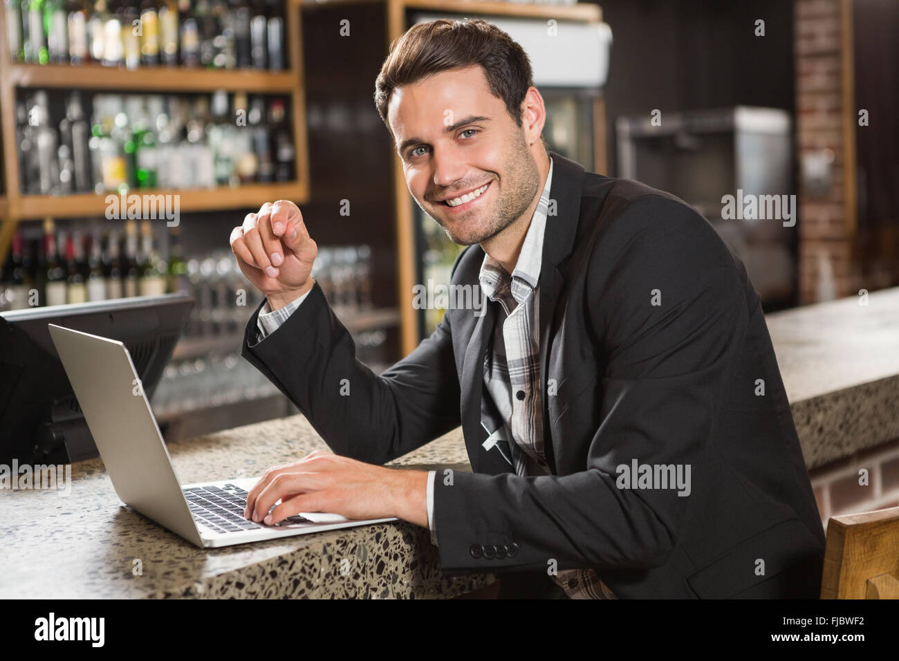 Handsome man using laptop computer Stock Photo - Alamy