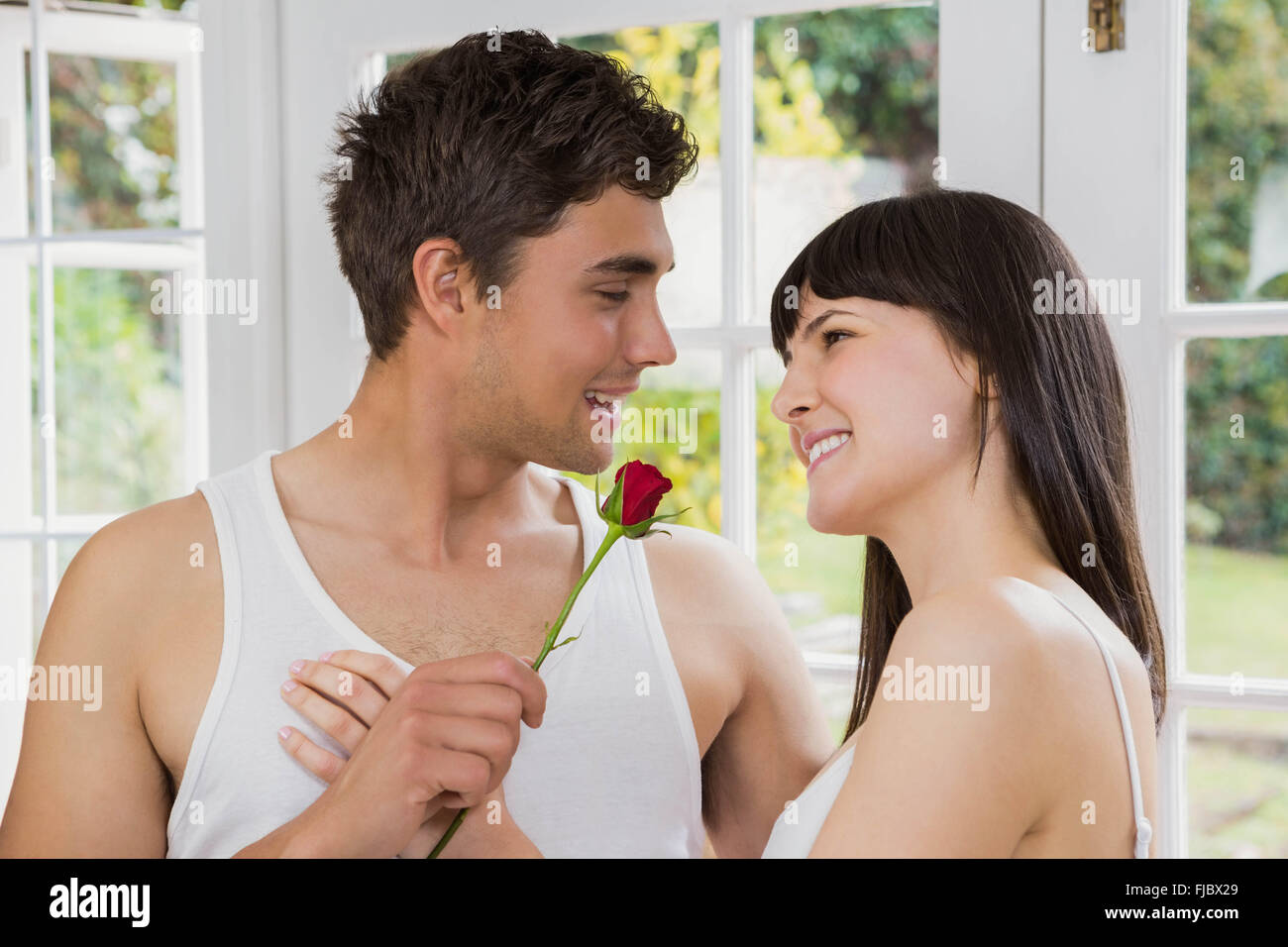 Man offering a red rose to woman Stock Photo - Alamy