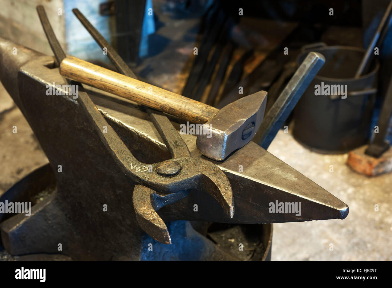 Old blacksmith's anvil with hammer and pincer, blacksmith's shop at the ...