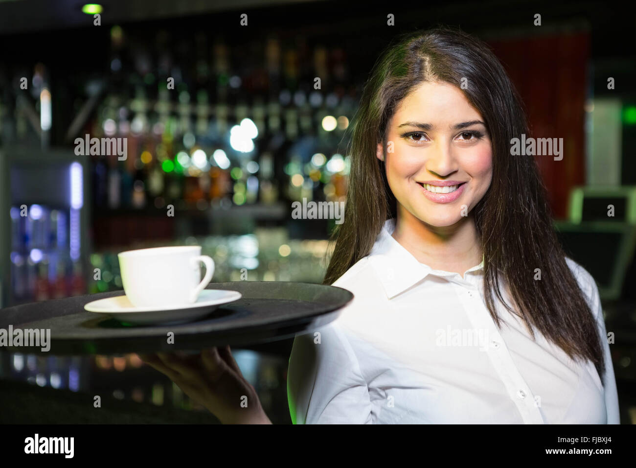 Portrait of pretty waitress serving a cup of coffee Stock Photo - Alamy