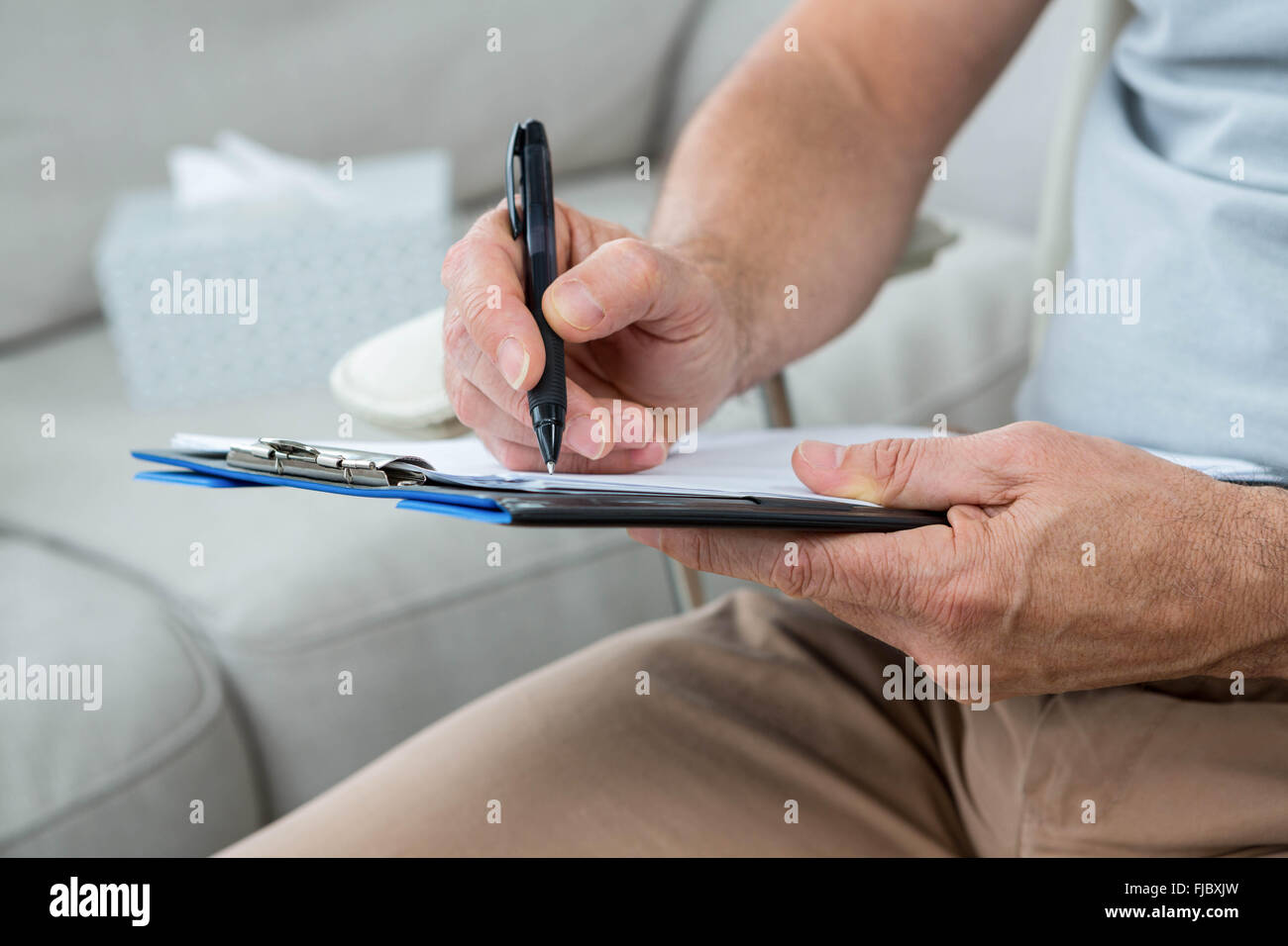 Man writing on notepad Stock Photo - Alamy