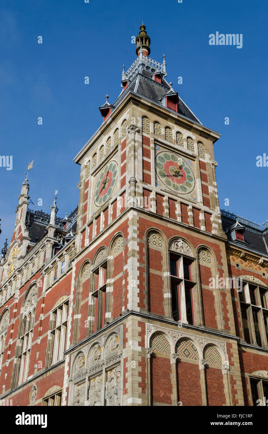 close up detail of clock tower on a red brick and sandstone building ...