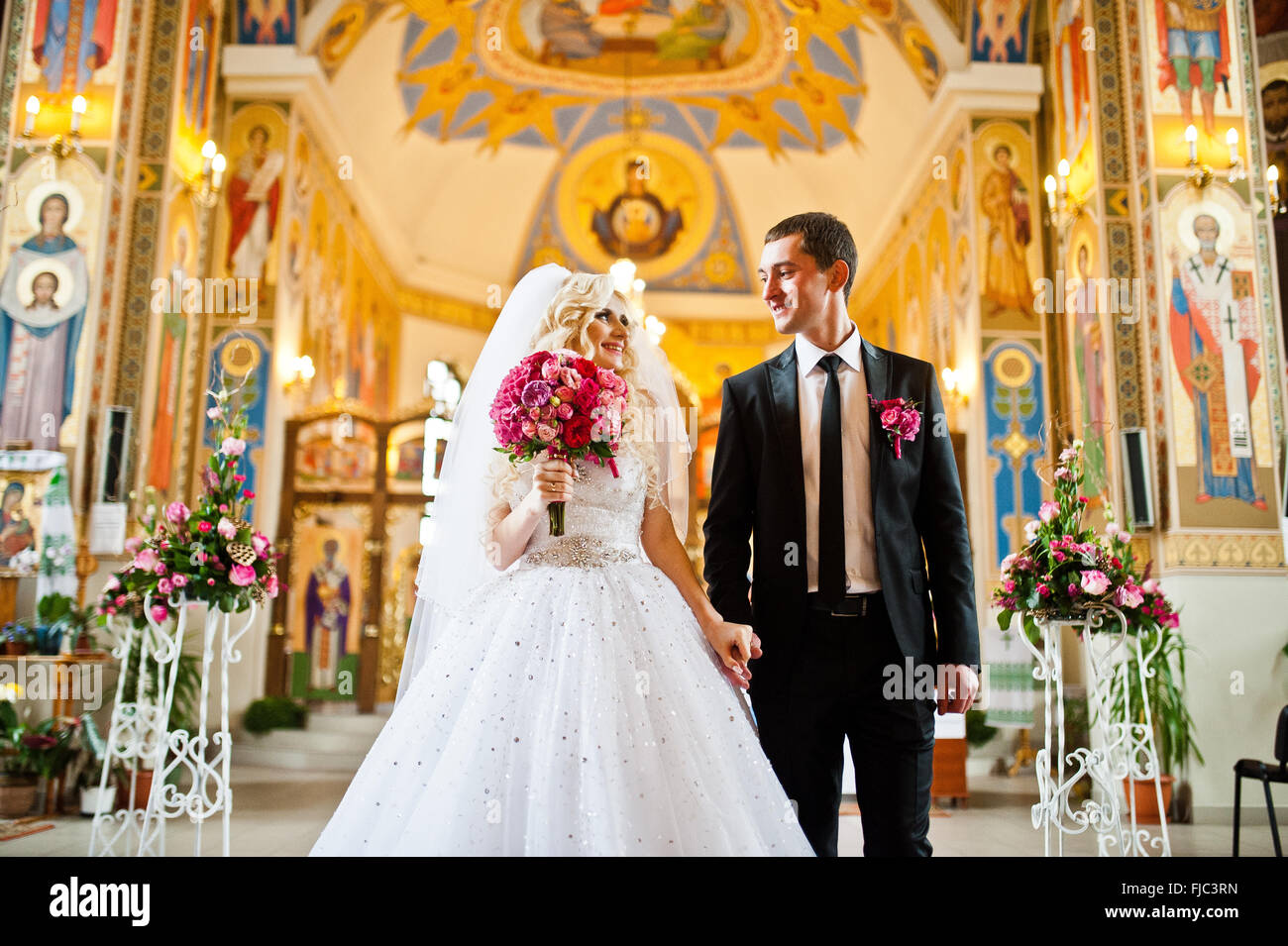 Stylish wedding couple at church Stock Photo - Alamy