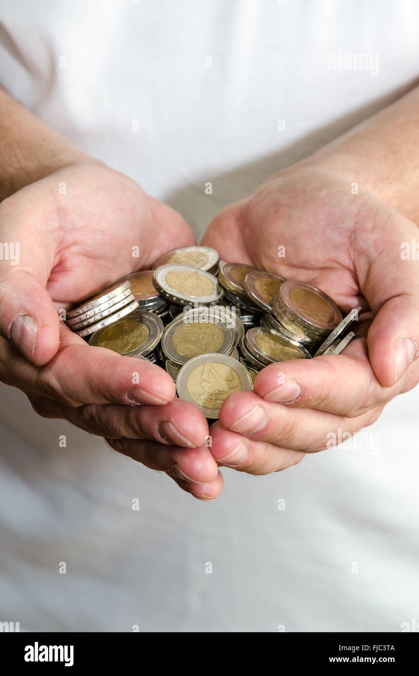 group of coins in human hands Stock Photo - Alamy