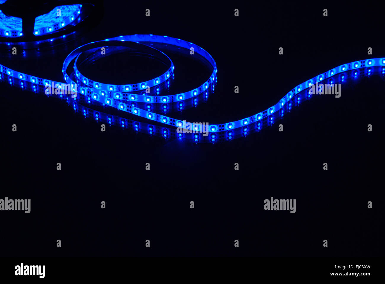 Blue led strip on the black background Stock Photo - Alamy