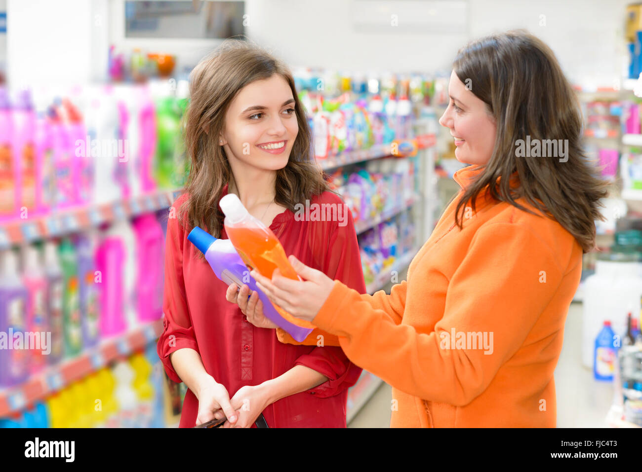 Happy sales woman showing some cleaning product in supermarket Stock ...