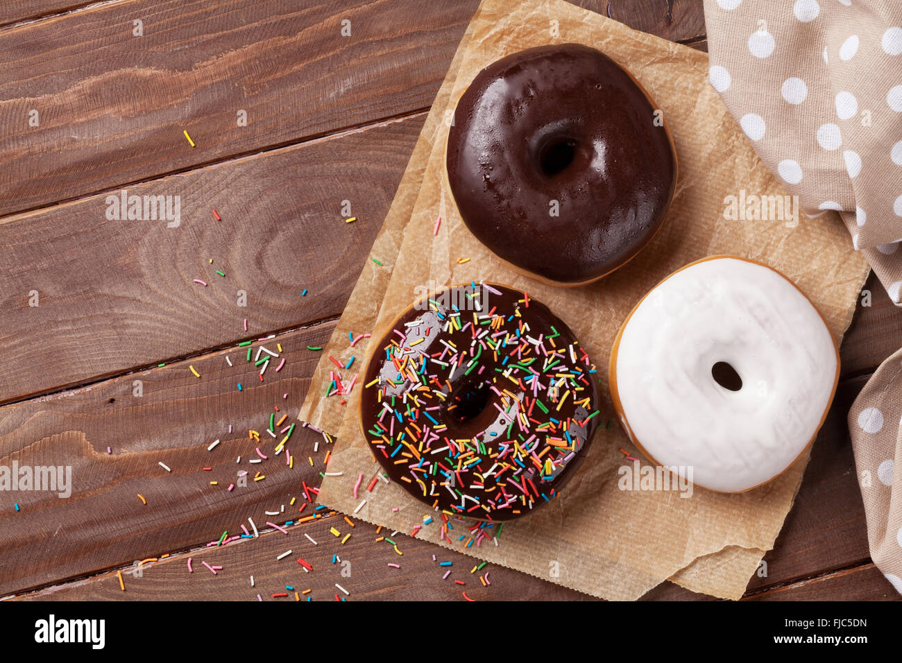 Colorful donuts on wooden table. Top view with copy space Stock Photo ...