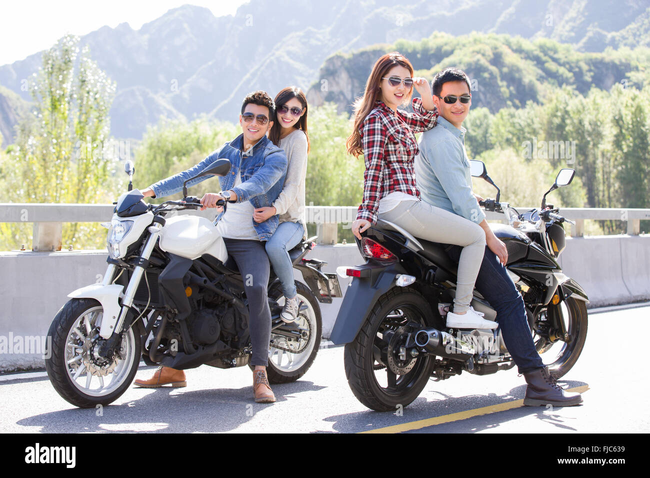 Young Chinese friends riding motorcycle together Stock Photo - Alamy