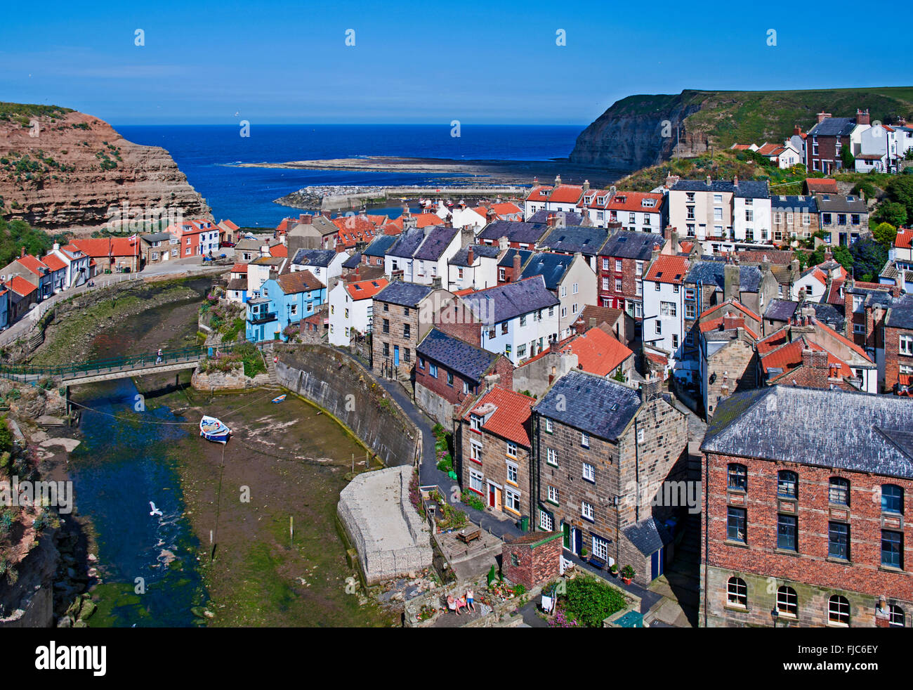 View over the rooftops of the coastal fishing village of Staithes ...