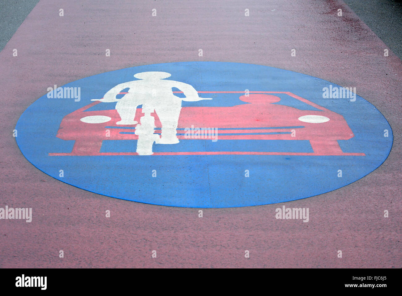 Painted red and blue bicycle priority lane sign Stock Photo - Alamy