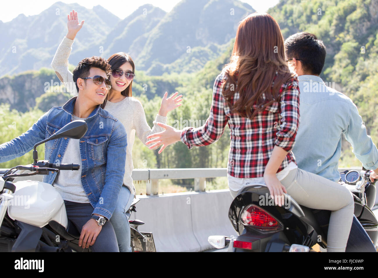 Young Chinese friends riding motorcycle together Stock Photo - Alamy