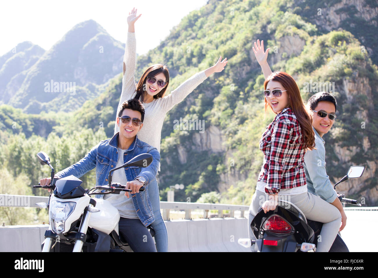 Young Chinese friends riding motorcycle together Stock Photo - Alamy