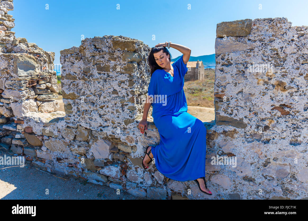 beautiful greek young brunet woman in blue dress Stock Photo - Alamy