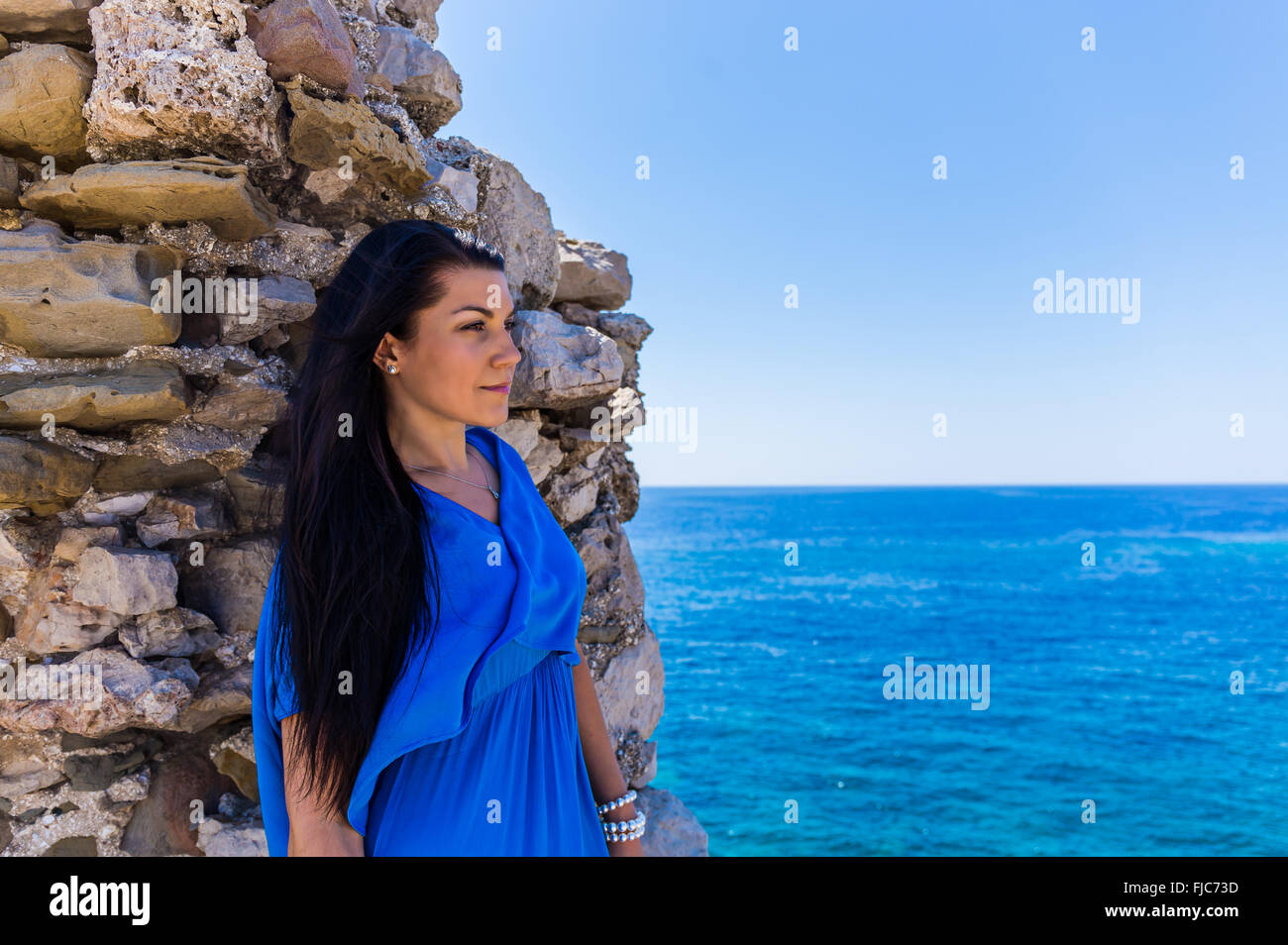 beautiful greek young brunet woman in blue dress Stock Photo - Alamy