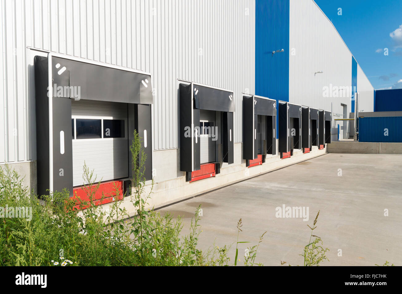 exterior of a newly build warehouse with loading docks Stock Photo - Alamy