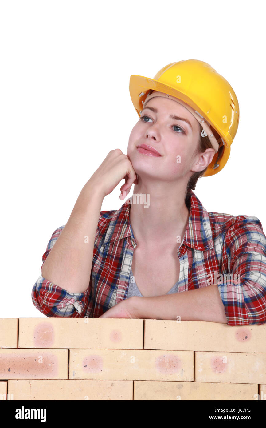 Female mason stood by wall Stock Photo - Alamy