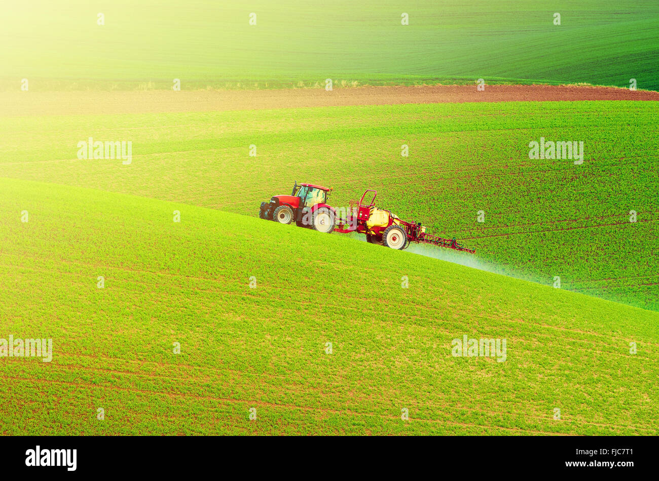 Farm machinery spraying insecticide Stock Photo - Alamy