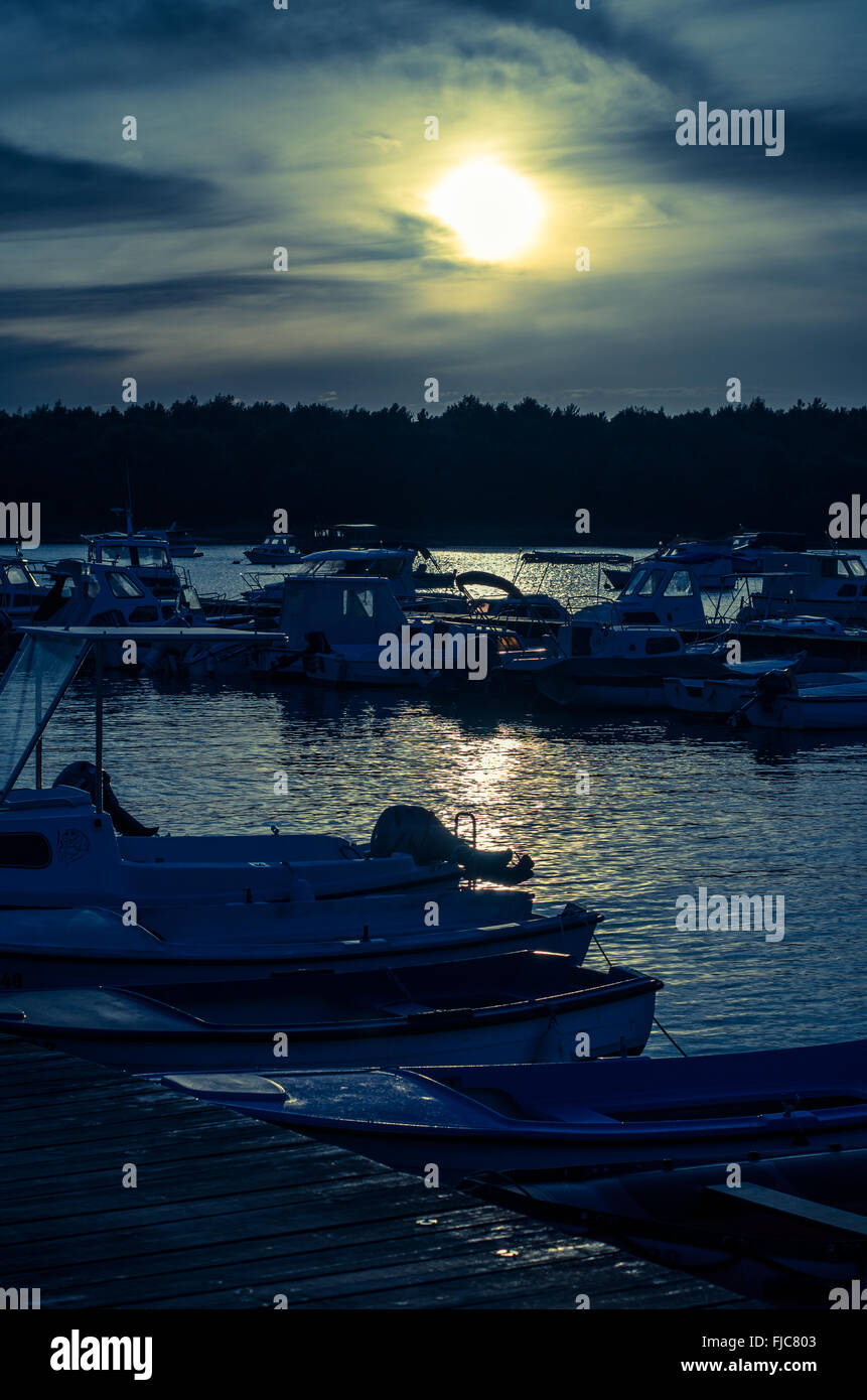 yellow blue sunset in harbour Stock Photo - Alamy