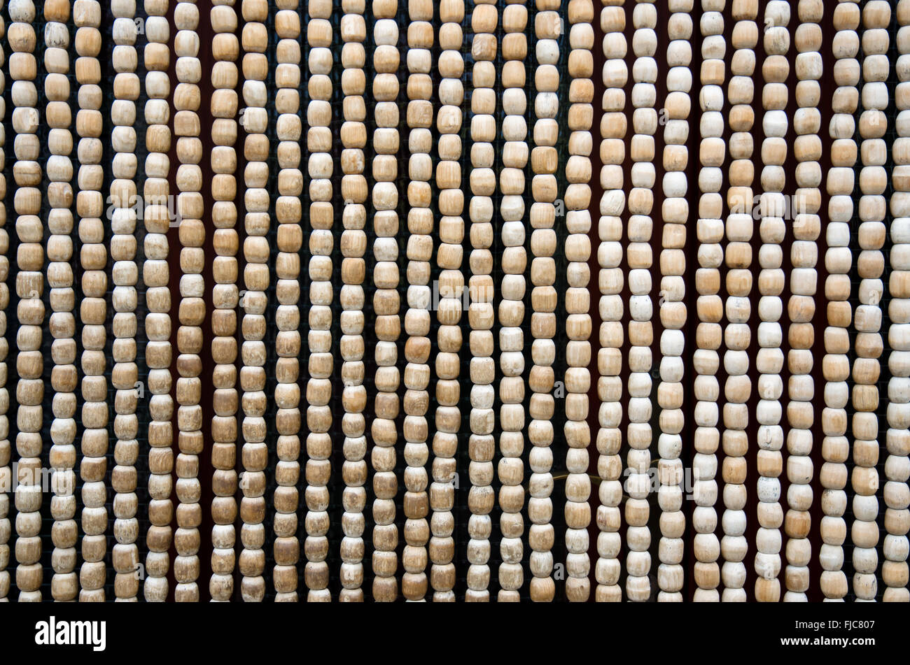 neutral regular wooden beads background Stock Photo - Alamy