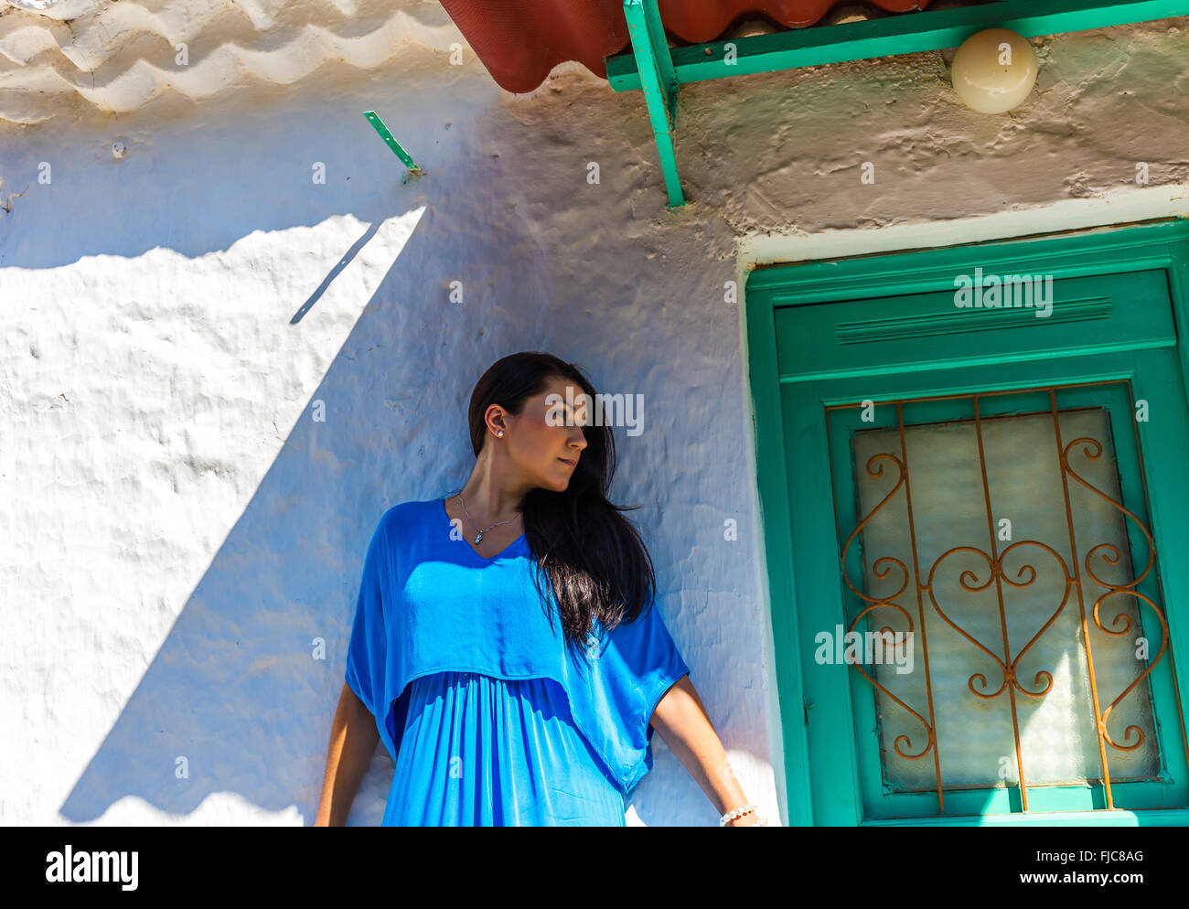 beautiful greek young brunet woman in blue dress Stock Photo - Alamy