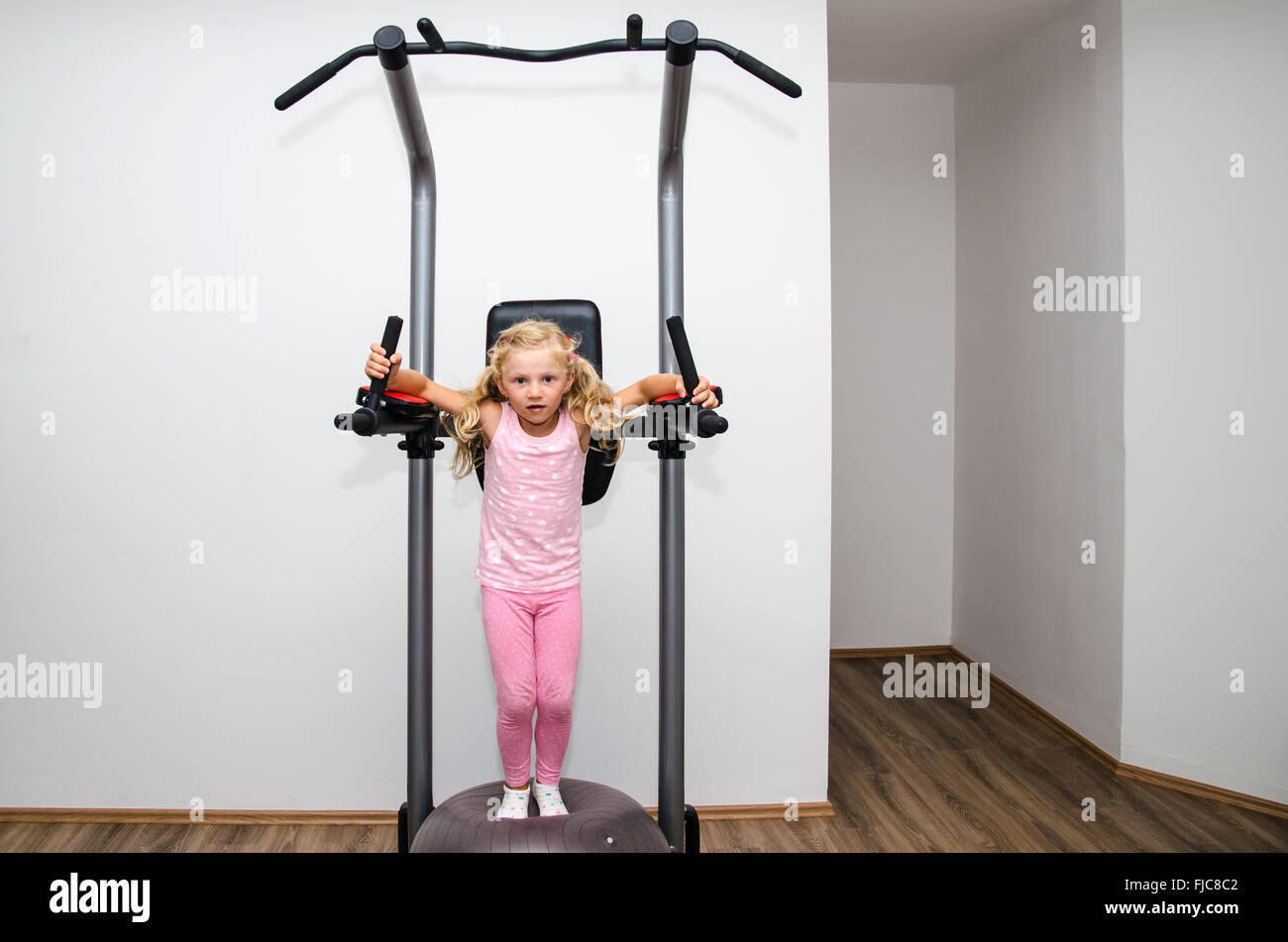 little blond girl working out in the gym equipment Stock Photo - Alamy