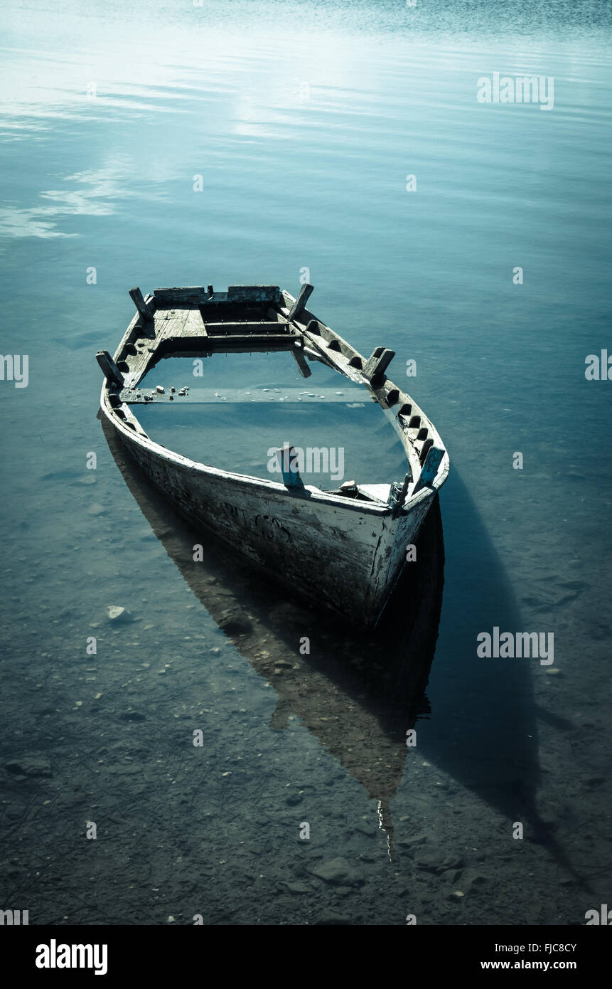 little wooden scuttled boat full of water in the sea Stock Photo - Alamy