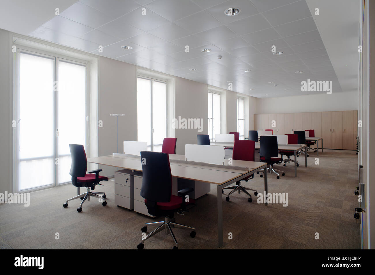Empty workstations in a office interior Stock Photo - Alamy