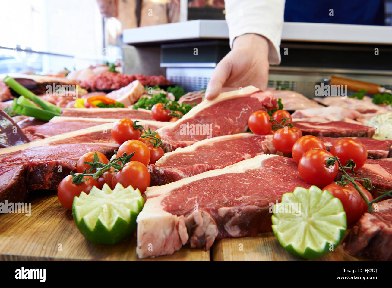 Butcher Showing Customer Sirloin Steak In Refrigerated Display Stock ...