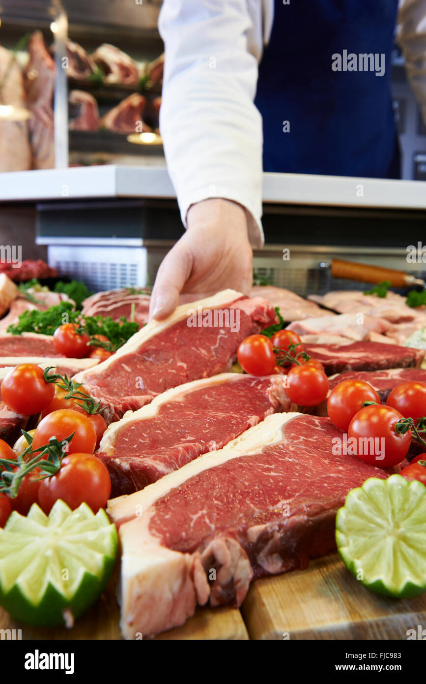 Butcher Showing Customer Sirloin Steak In Refrigerated Display Stock ...