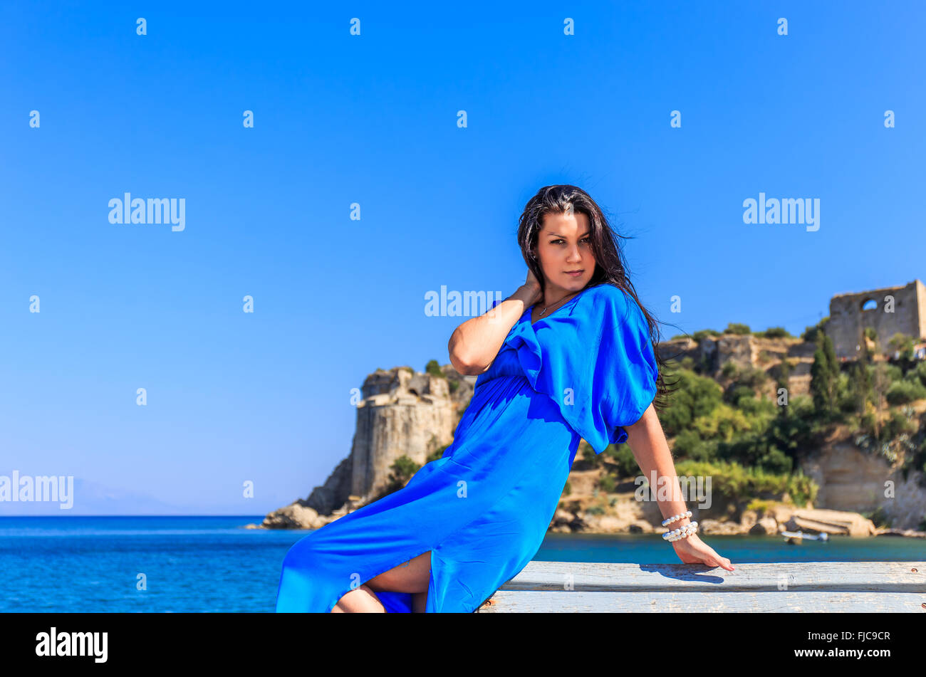 beautiful greek young brunet woman in blue dress Stock Photo - Alamy